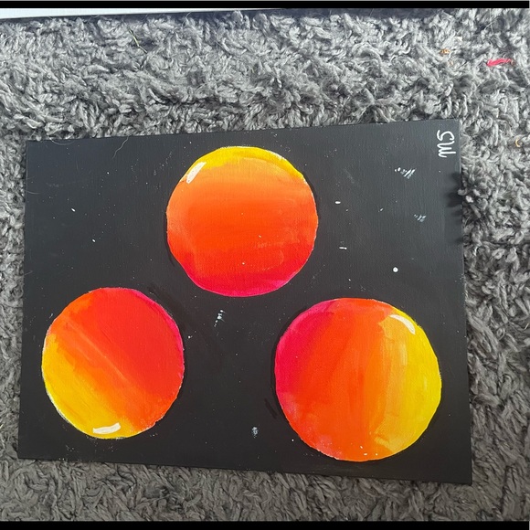 Wall Decor | A Painting Of Three Sun Type Objects On A Black Background ...